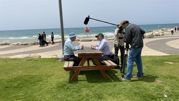 Shaul Ladany (seated, left) and Jeremy Schaap (seated, right) in Tel ...